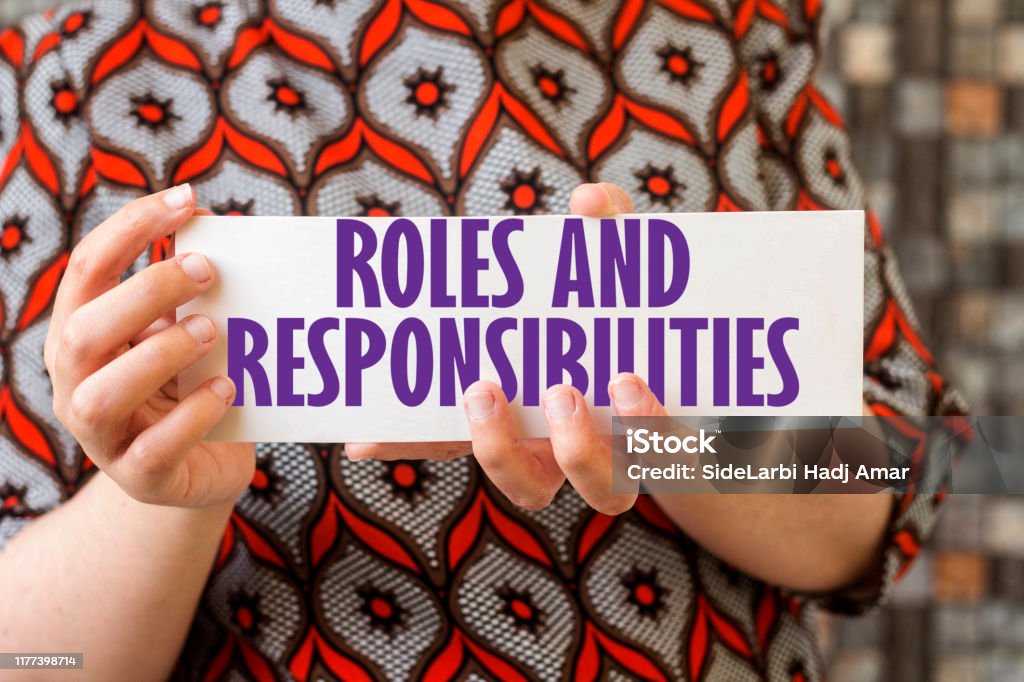 Businessman Holding White Paper With Text Roles And Responsibilities ... Businessman Holding White Paper With Text Roles And Responsibilities ...