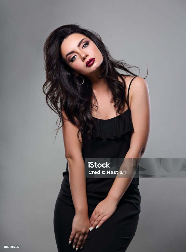 Beautiful Bright Makeup Woman With Long Black Curly Hair Style In Black