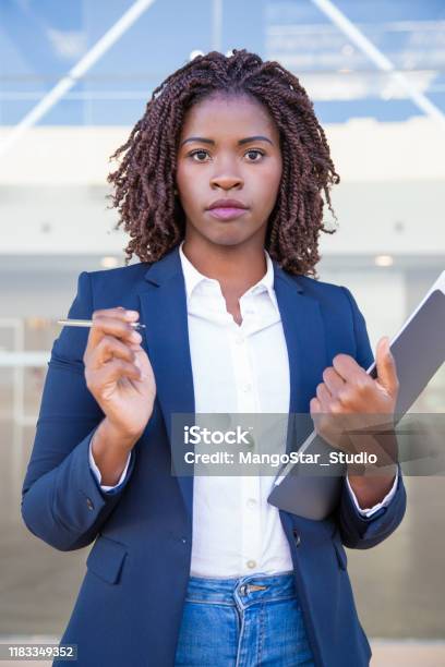 Serious Confident Manager With Documents Posing Outside Stock Photo ... Serious Confident Manager With Documents Posing Outside Stock Photo ...