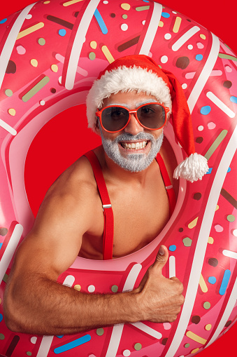 Christmas Freestyle Young Santa Claus Bare Muscular Upper Body In Hat And Sunglasses Standing