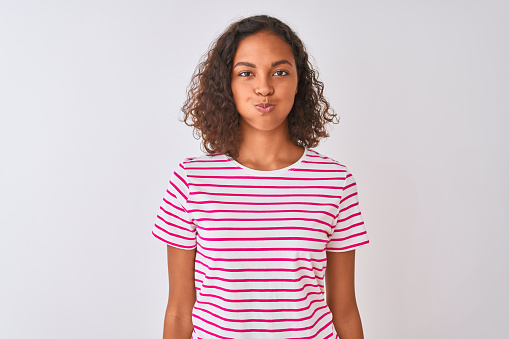 Young Brazilian Woman Wearing Pink Striped Tshirt Standing Over