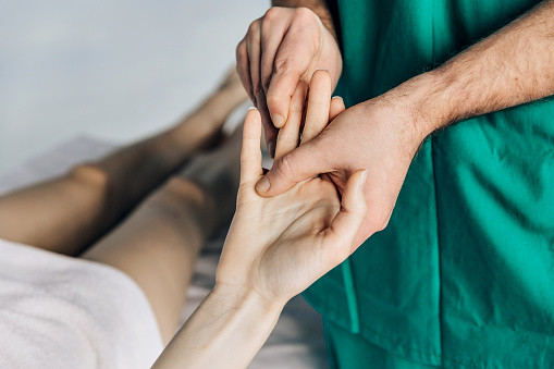 Wrist Massage A Male Massage Therapist Puts Pressure On A Sensitive