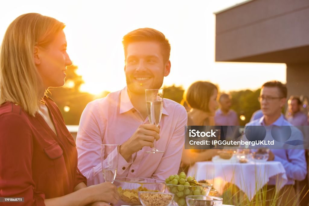 Businessman Drinking Champagne With Colleagues In Rooftop Success Party