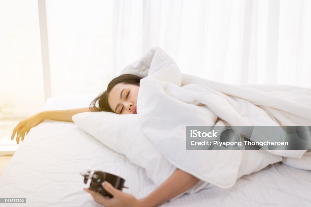 Bored Young Asian Woman Hates Getting Stressed Waking Up Early On Bed