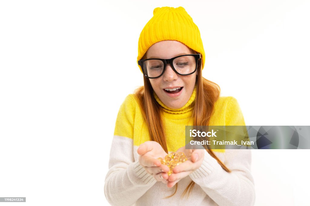 Smiling European Redhaired Girl In Glasses Holds Lenses On A White