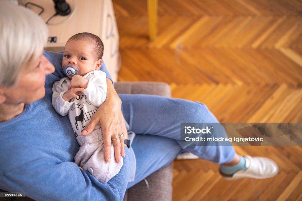 Grandmother Holding Newborn Grandson In Her Arms Until His Mother