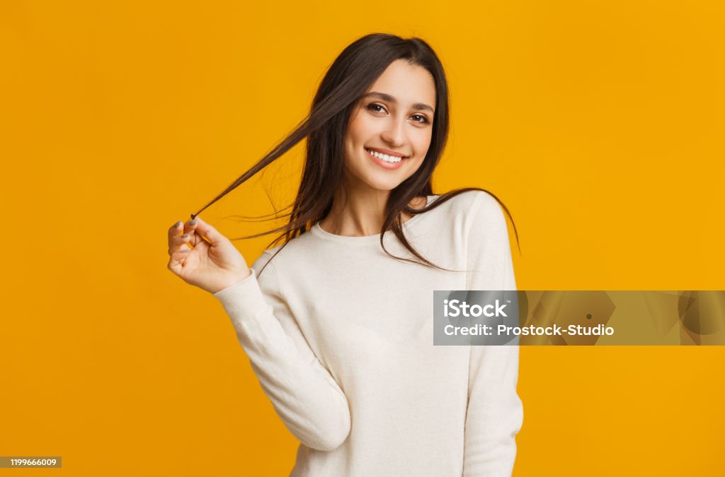 Happy Brunette Girl Flirting And Touching Her Long Beautiful Hair Stock