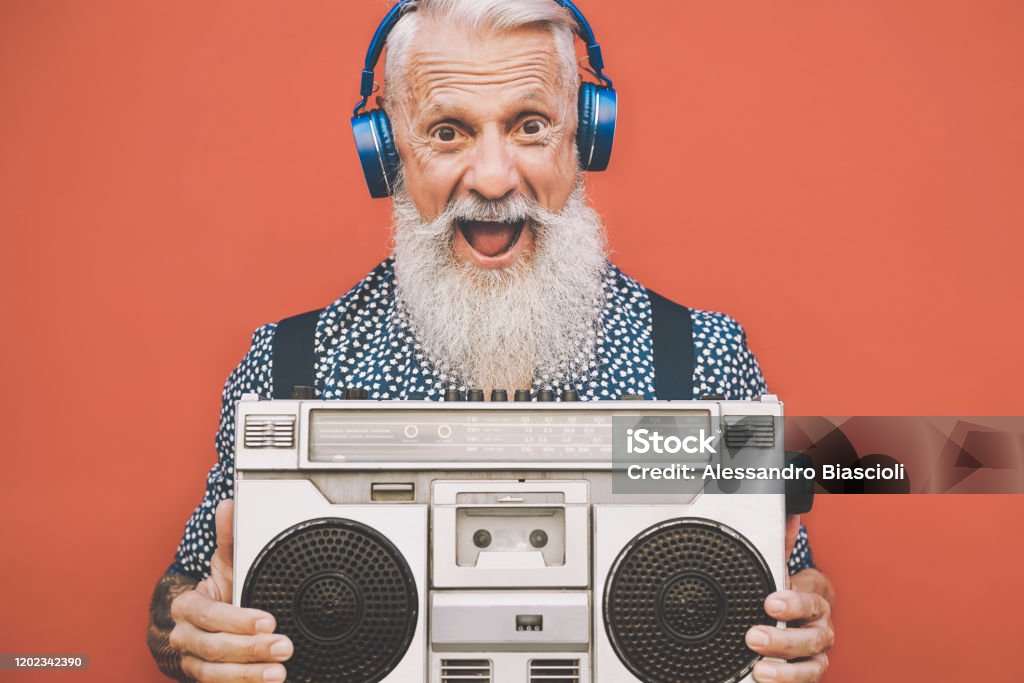 Happy Senior Man Listening To Music With Boombox And Headphones Outdoor