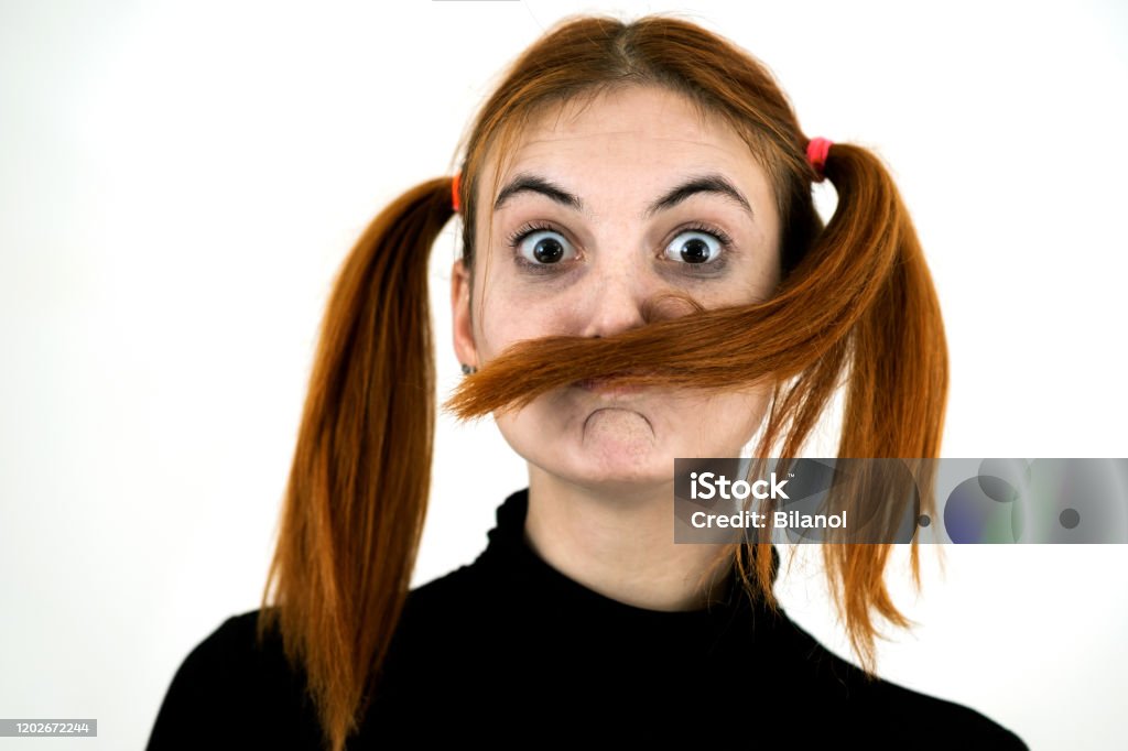 Close Up Portrait Of Pretty Redhead Teenage Girl Fooling Around Stock
