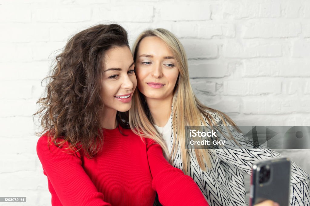 Two Young Adult Caucasian Girlfriends Having Fun And Enjoy Spending