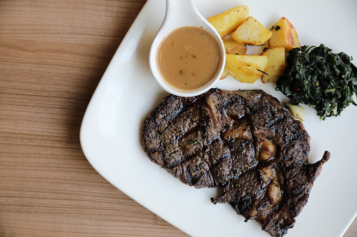 Steak Daging Sapi Dengan Kentang Di Latar Belakang Kayu Foto Stok