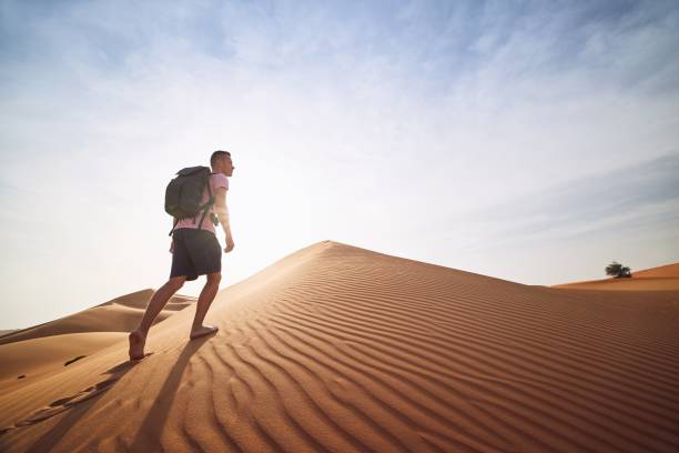 Free Stock Photo of Man Walking Across Desert With Backpack | Download ...
