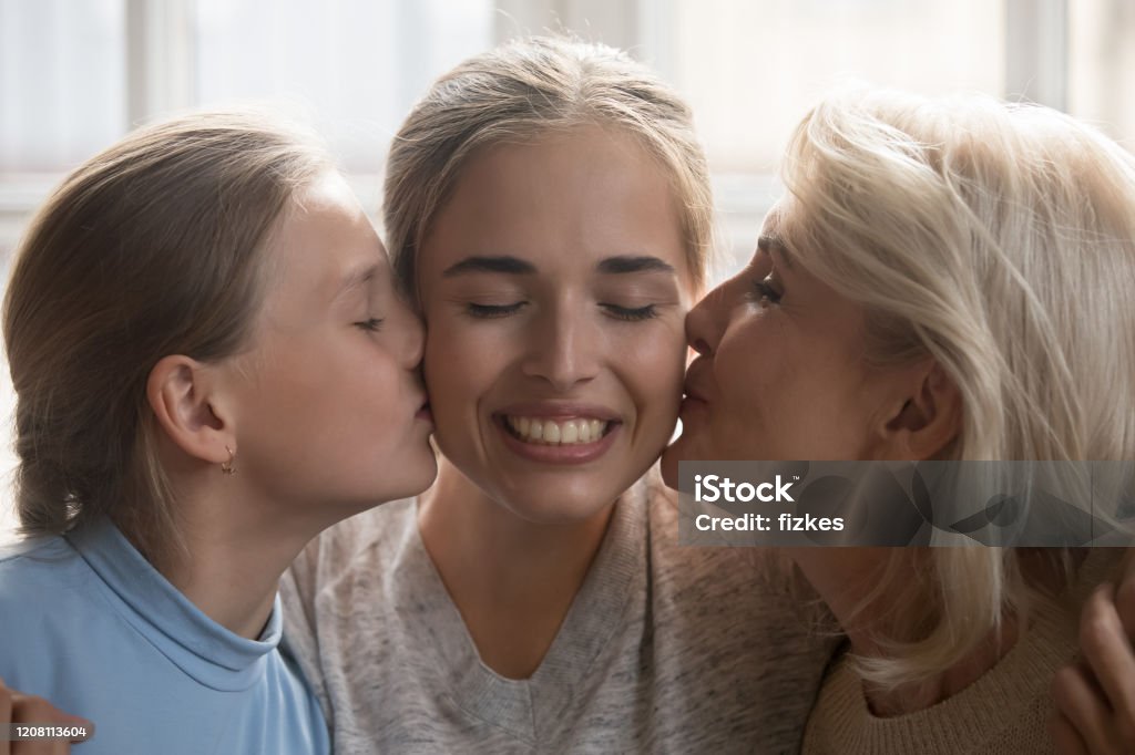 Closeup Faces Woman Her Daughter And Elderly Mother Kiss Her Stock