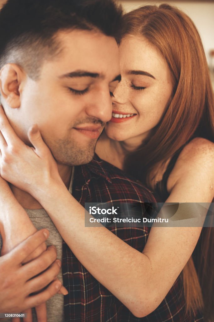 Close Up Portrait Of A Caucasian Couple Embracing With Closed Eyes And