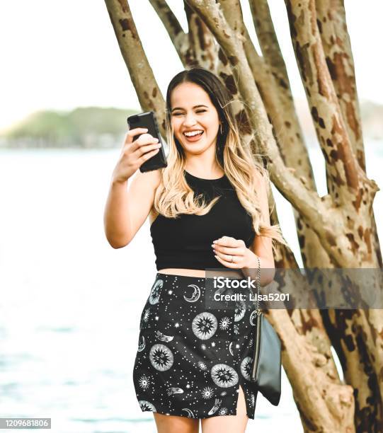 Beautiful Young Latina Woman 18 Year Old Uses Cell Phone Outdoors Stock