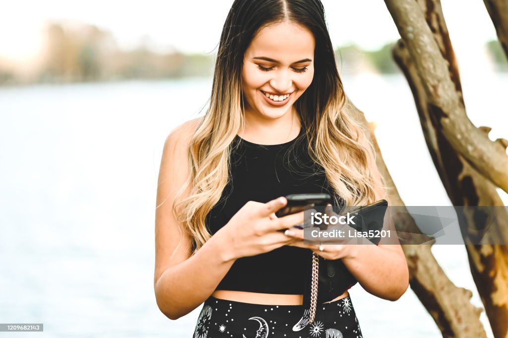 Beautiful Young Latina Woman 18 Year Old Uses Cell Phone Outdoors Stock
