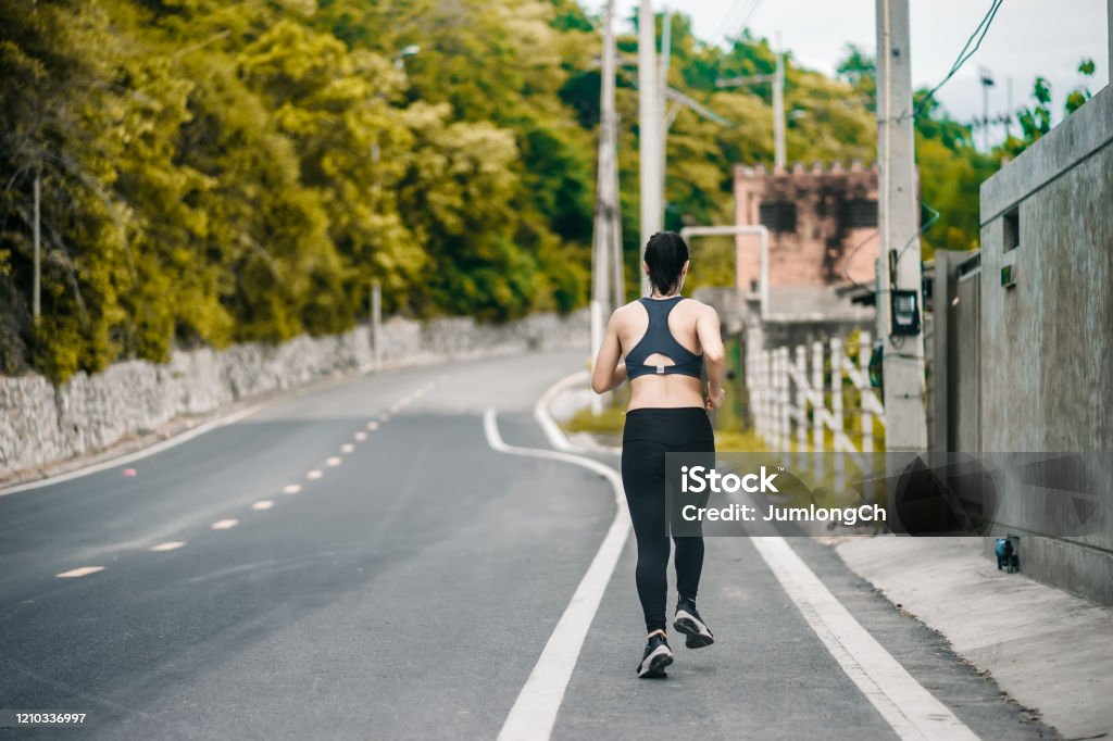 Asian Fitness Woman Runner Stretching Legs Before Run Outdoor Workout
