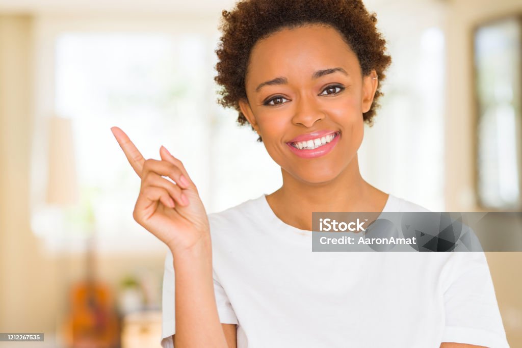 Young Beautiful African American Woman Wearing Casual White Tshirt With