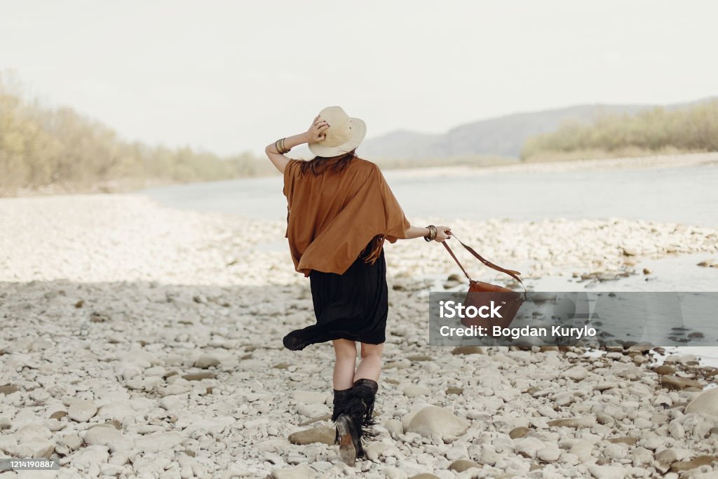 Happy Stylish Hipster Traveler Woman In Hat Fringe Poncho Back View