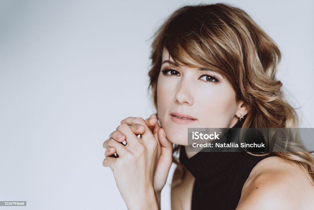 Portrait Of A 36yearold Woman With Curly Hair And Brown Slanting Eyes