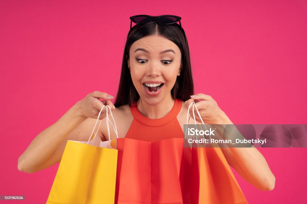 Image Of Joyous Young Asian Woman Expressing Surprise And Holding