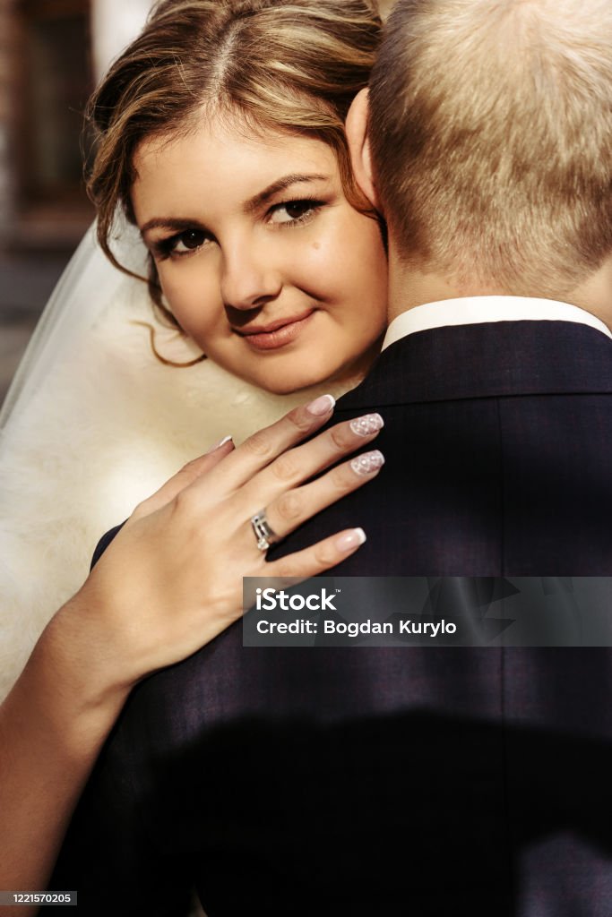 Happy Gorgeous Blonde Bride And Stylish Handsome Groom Hugging With