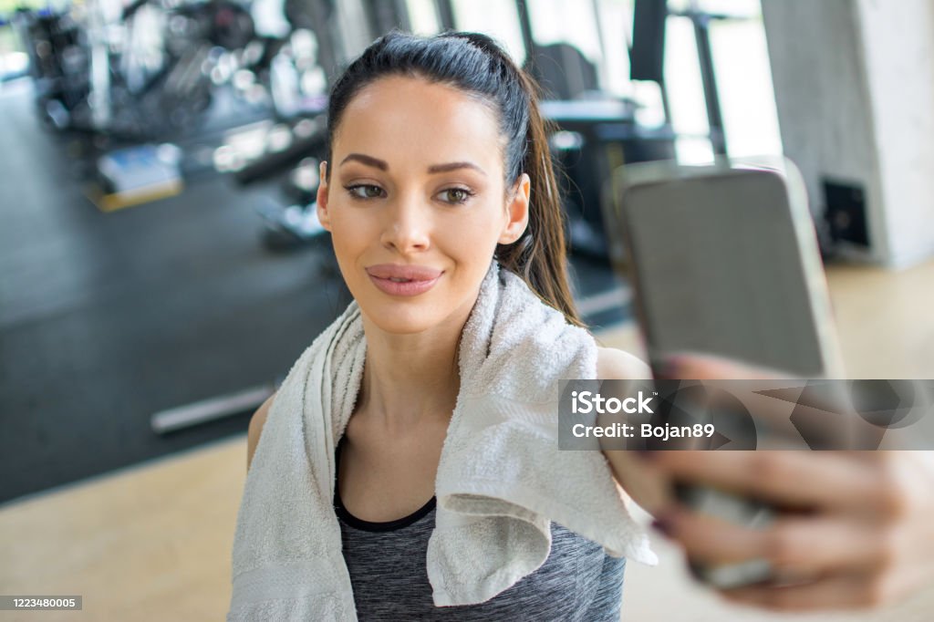 Young Fitness Woman Taking Selfies After Training In The Gym Stock