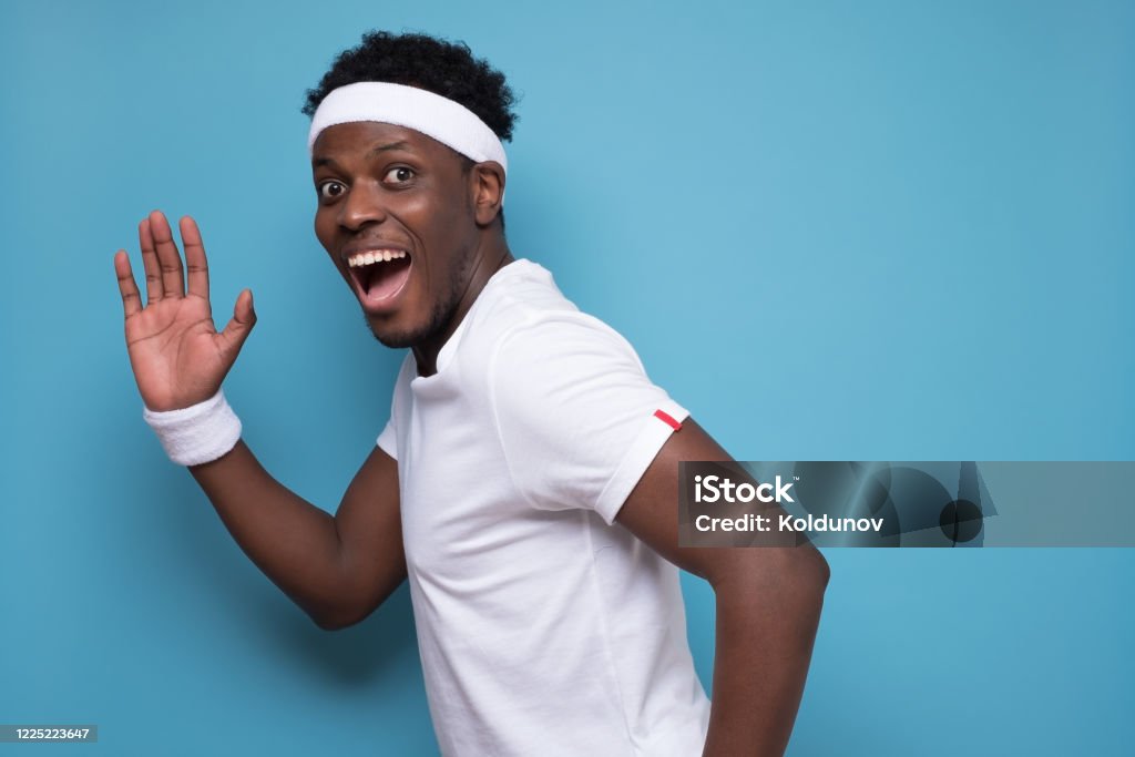 African American Young Man Running Away And Looking At Camera And ... African American Young Man Running Away And Looking At Camera And ...