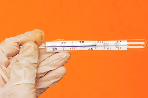 Hand Holding Thermometer Of Human Has Been Infected Showing High