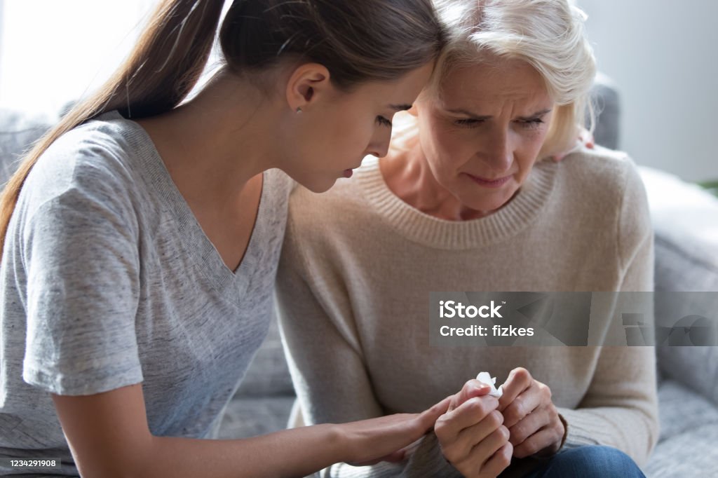 Worrying Millennial Lady Sitting Next To Upset Frustrated Mommy Stock