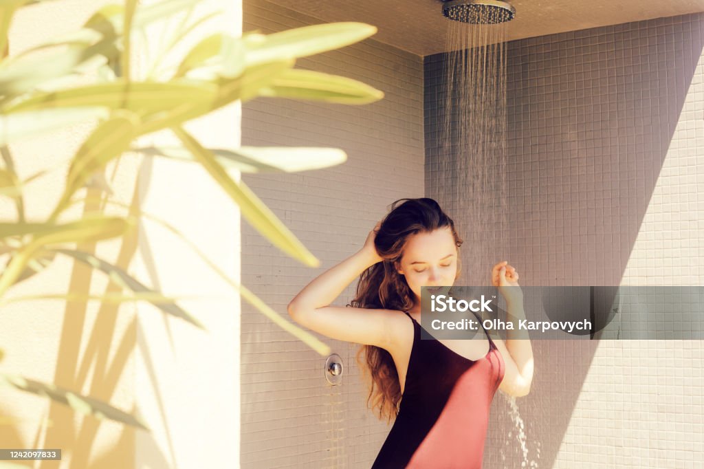 A Girl Takes A Shower In The Street In A Public Shower A Girl With Long