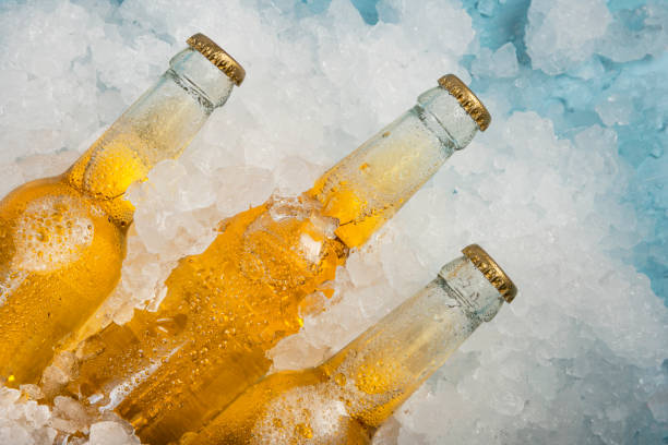 Free Stock Photo of Cold bottles of beer in ice on yellow background ...