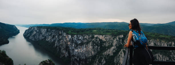 Free Stock Photo of Woman Standing on Cliff Overlooking River ...