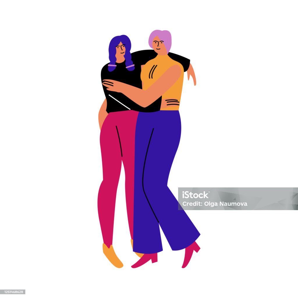 A Happy Lesbian Couple Of Women Standing In Casual Clothes And Hugging