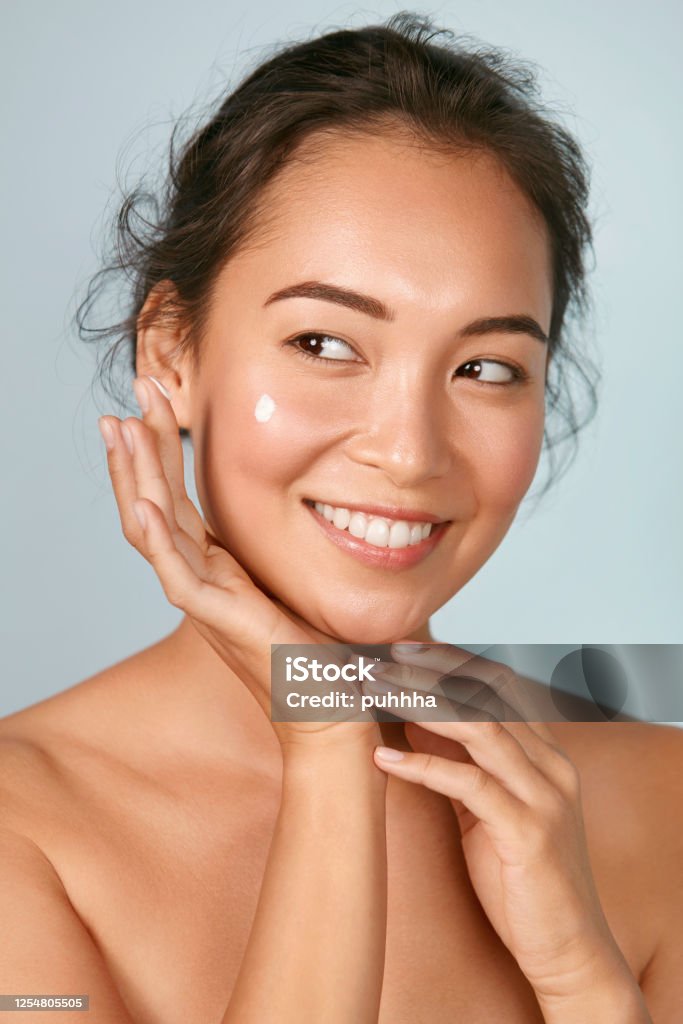 Face Skin Care Woman Applying Cosmetic Cream On Skin Portrait Stock