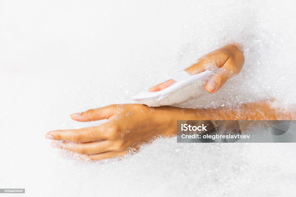 Woman Washing Hands In Bath Tub With Foam Bubbles And Use Natural Jute