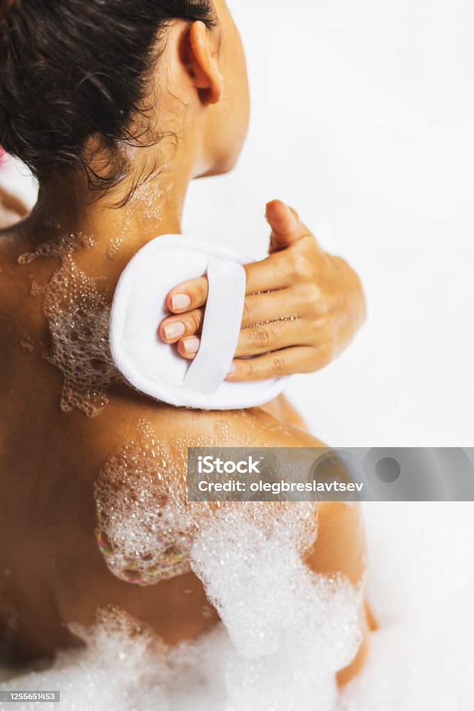 Woman Taking A Bath And Washing With Natural Jute Sponge Tub With Foam