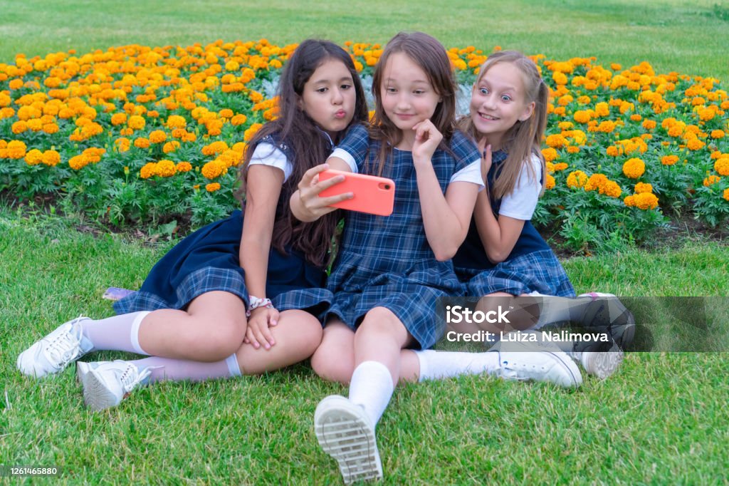 Three Teen Girls Take A Selfie Phone On A Sunny Day And Laugh Emotions