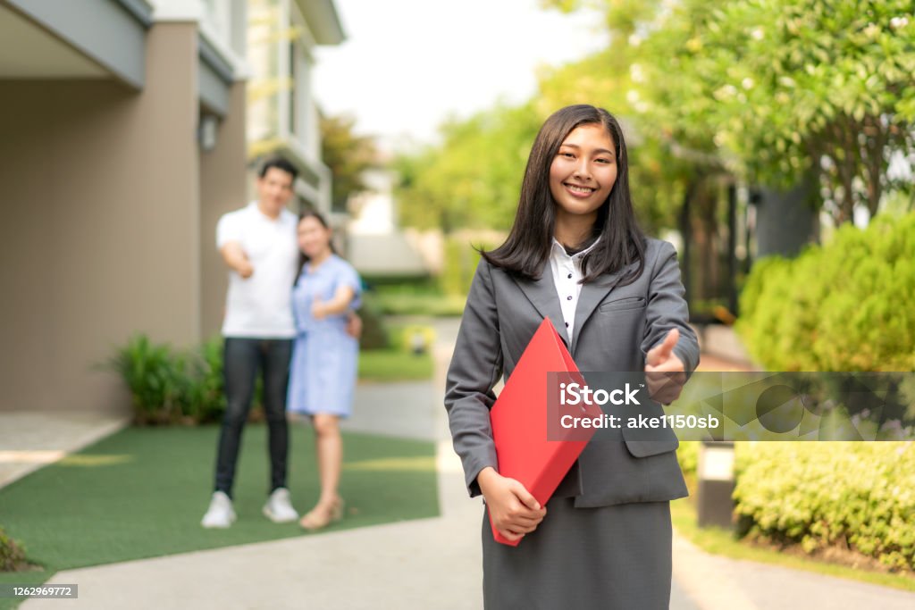 Asian Real Estate Agent Or Real Estate Agent Woman Smiling And Holding Red File With Thumb Up