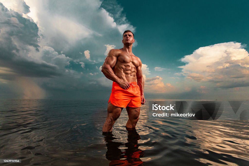 Fit Athlete Bodybuilder On The Beach Attractive Young Man Lifeguard On