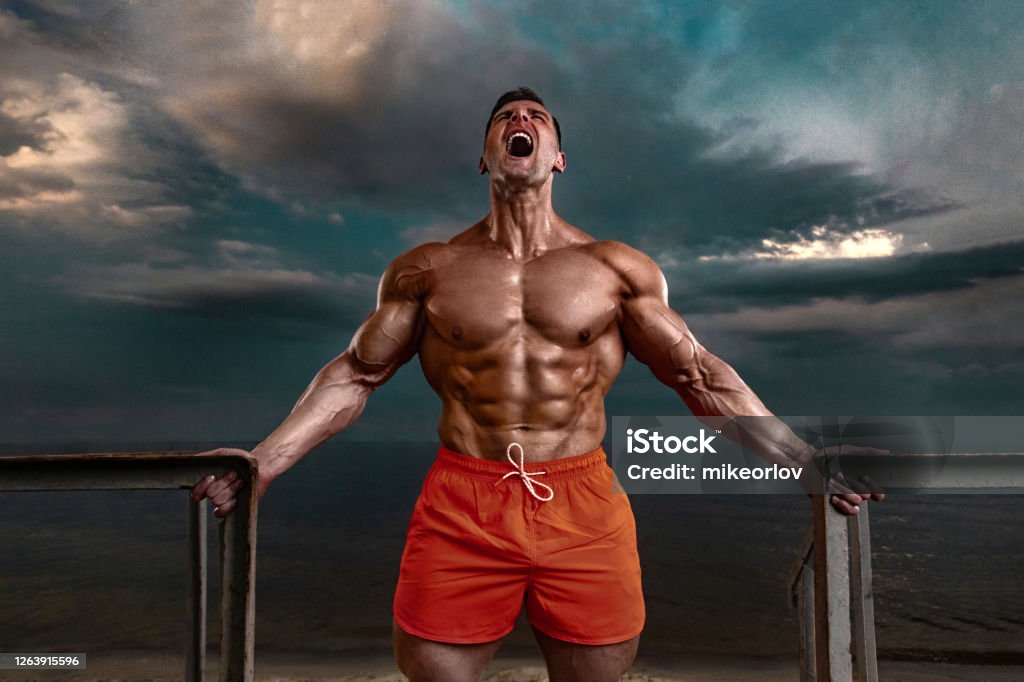 Fit Athlete Bodybuilder On The Beach Attractive Young Man Lifeguard On