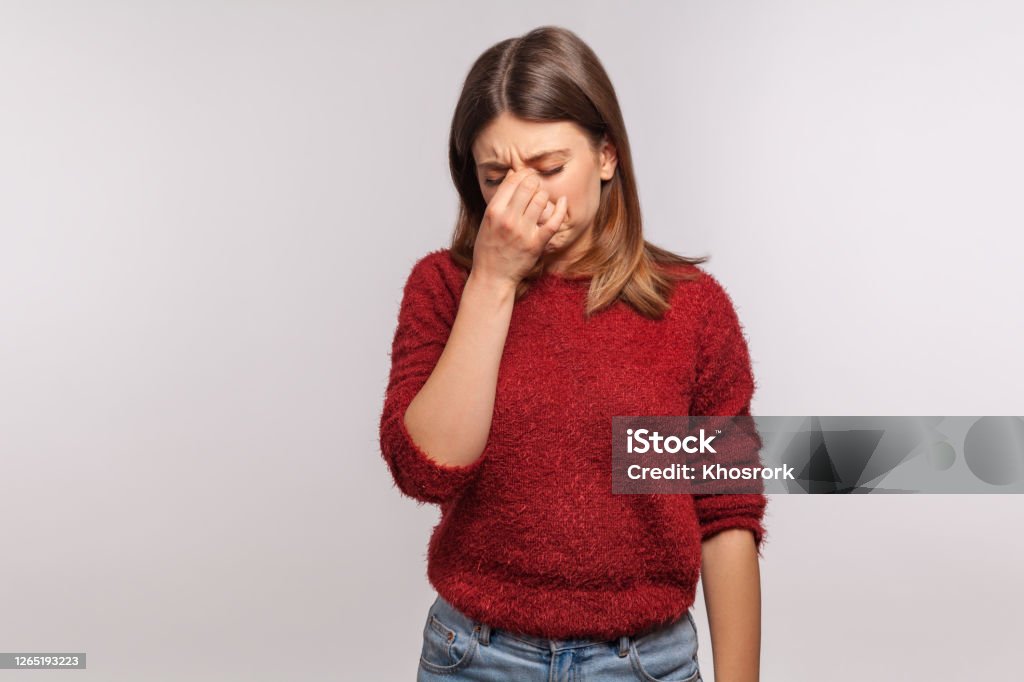 Depression Portrait Of Upset Girl Touching Nose And Frowning Wiping