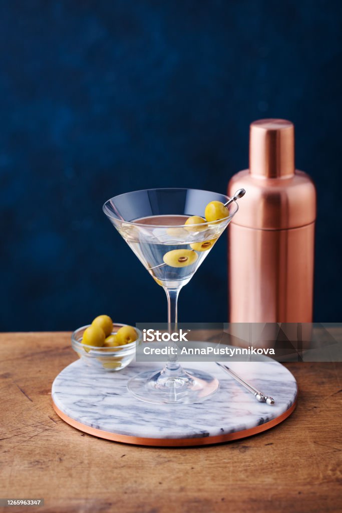 Martini Cocktail With Green Olives Shaker On Marble Board Wooden Table