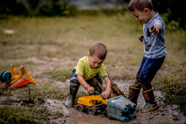Free Stock Photo of Young children playing in puddle mud together ...