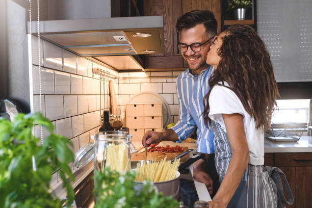 Free Stock Photo of Two young men cooking together in a modern kitchen ...