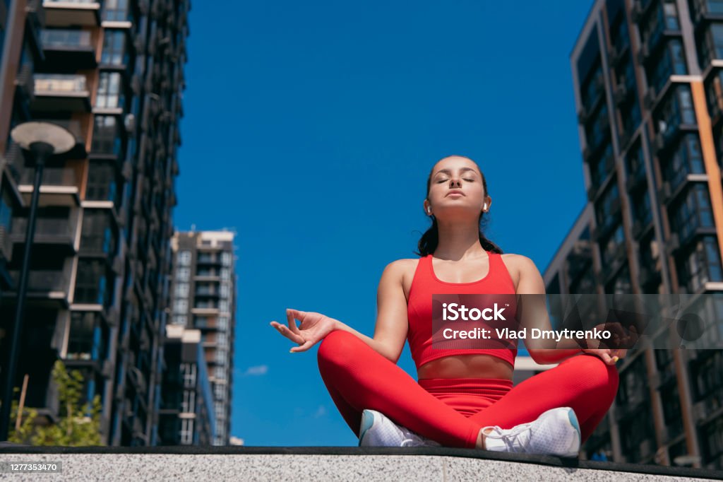 Flexible Wellbuilt Girl Relaxing In Lotus Yoga Pose Woman In Red
