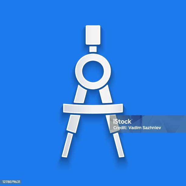 Icône De Boussole De Dessin De Coupe De Papier Isolée Sur Le Fond Bleu