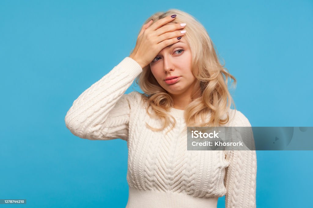 Depressed Hopeless Woman With Curly Blond Hair Making Facepalm Gesture