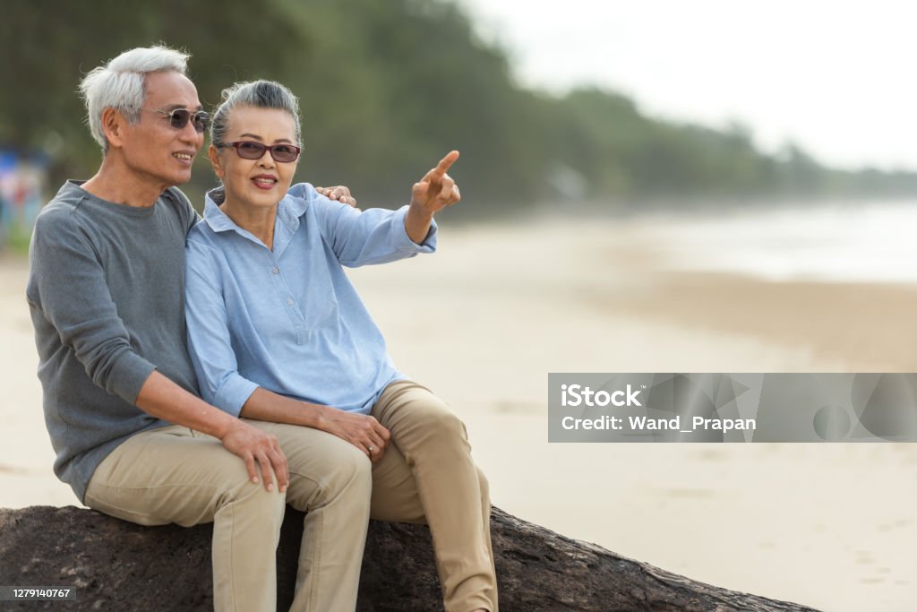 Asian Lifestyle Senior Couple Pointing And Hug See Beach Happy In Love
