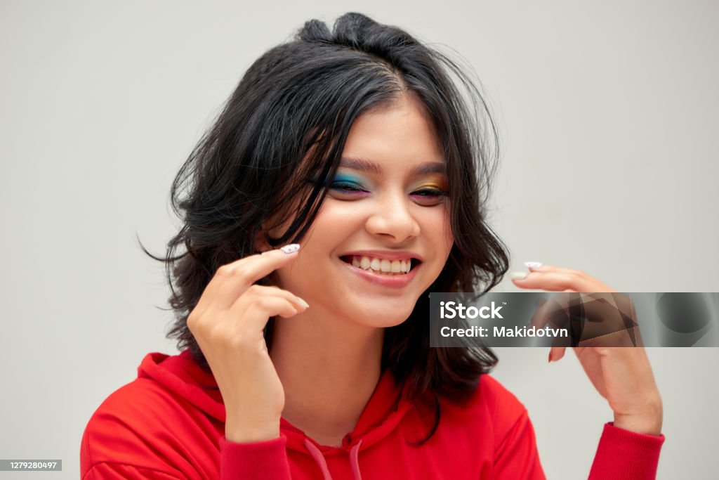 Adorable Asian Girl In Red Outfit Posing With Happy Face Expression